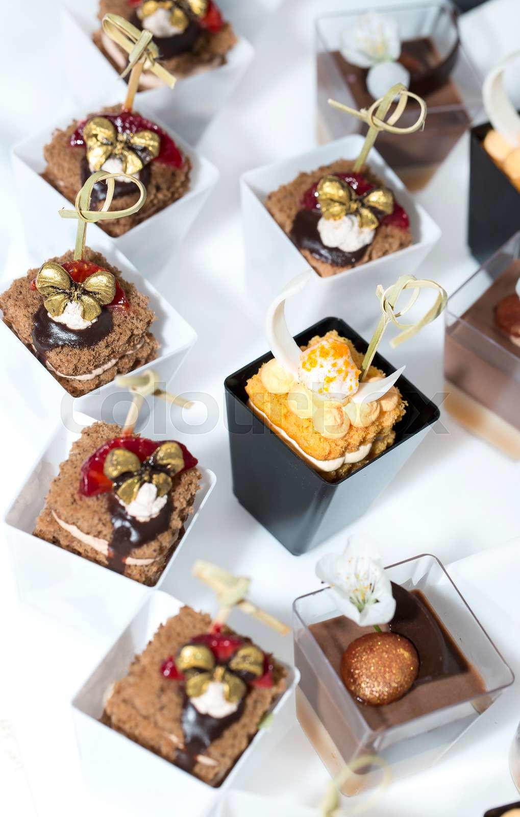 mini canapes in plastic cups decorated with edible flowers | Stock ...