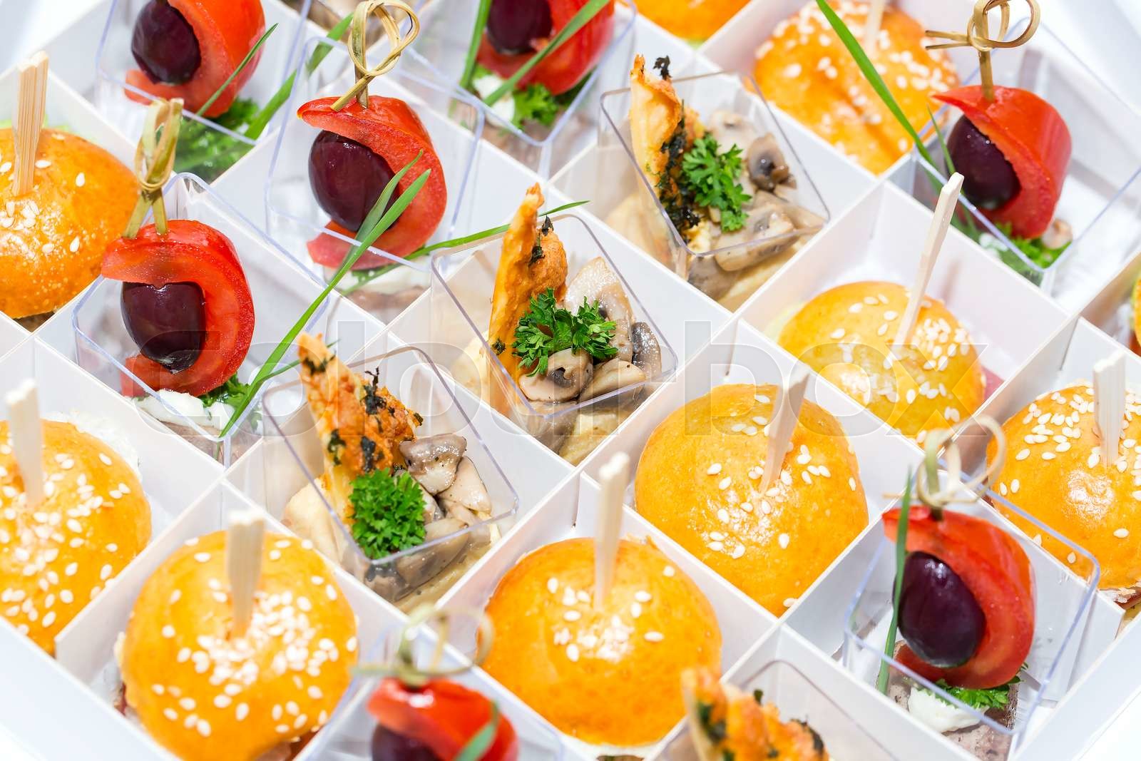 mini canapes in plastic cups decorated with edible flowers | Stock ...