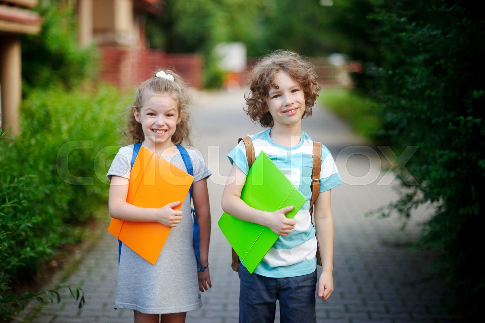 Boy and gerl on the way to school. | Stock image | Colourbox