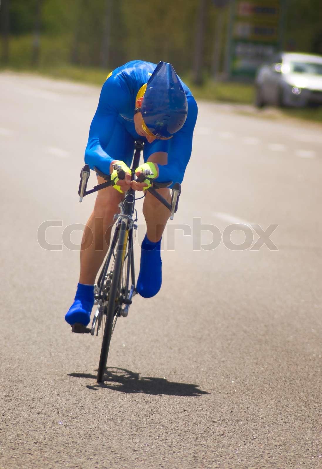 Cyclist riding a bike on an open road | Stock image | Colourbox