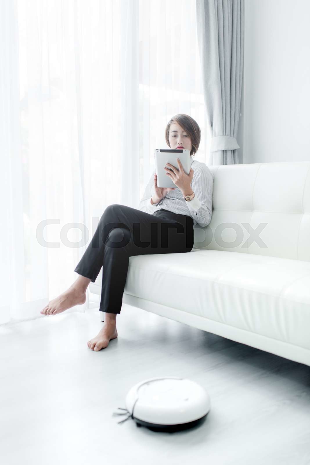 Modern life concept, woman relaxing with tablet, automatic robotic ...