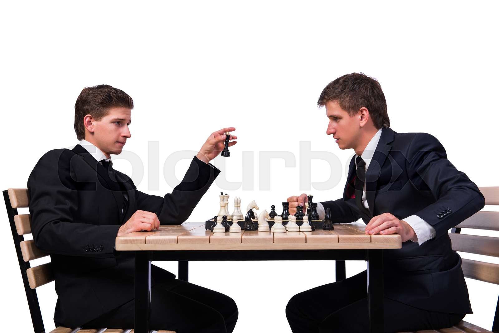Twin brothers playing chess isolated on white | Stock image | Colourbox