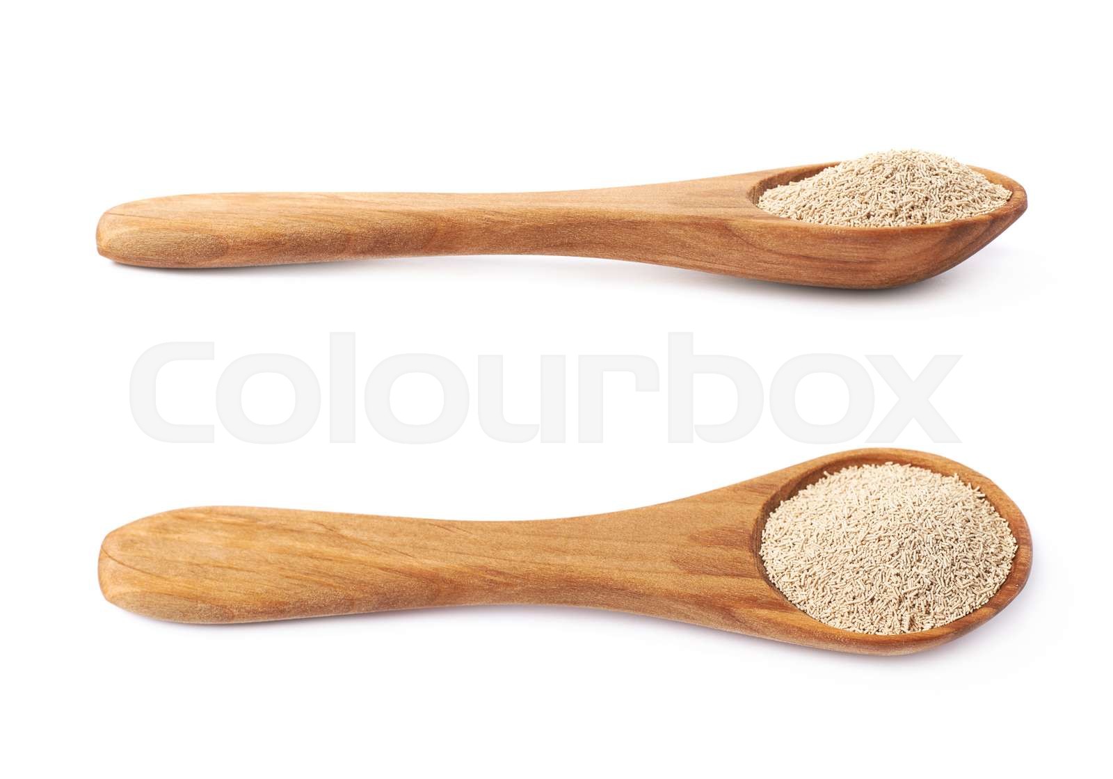 Wooden spoon filled with dry yeast | Stock image | Colourbox