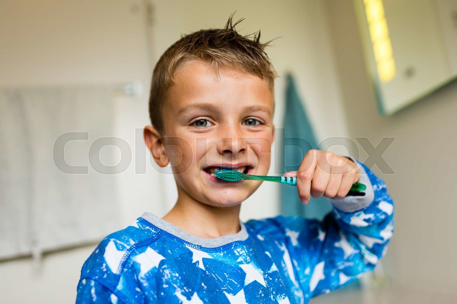 Young child brushing teeth with toothbrush | Stock image | Colourbox
