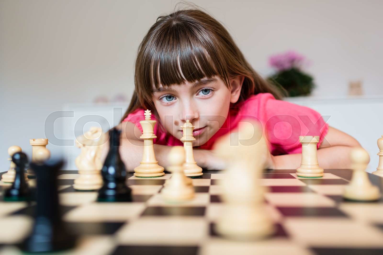 Girl and chess pieces | Stock image | Colourbox
