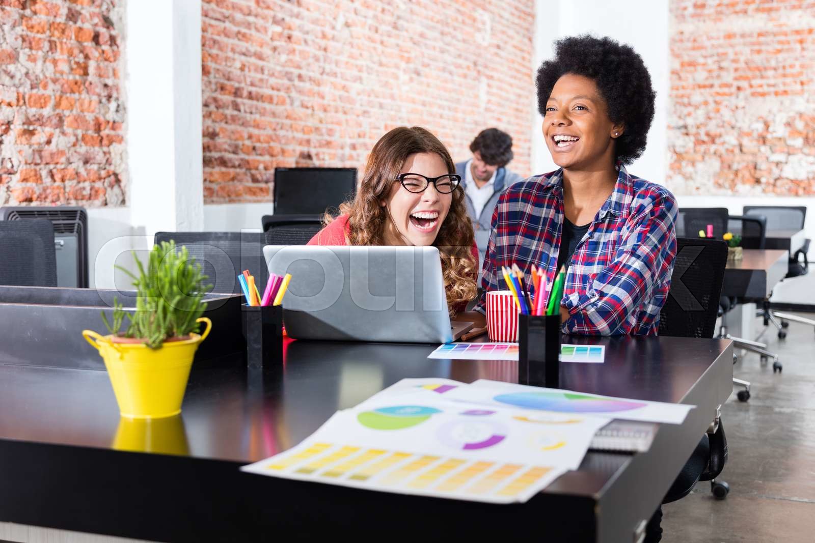 People laughing sitting office desk laptop colleagues fun joke | Stock ...