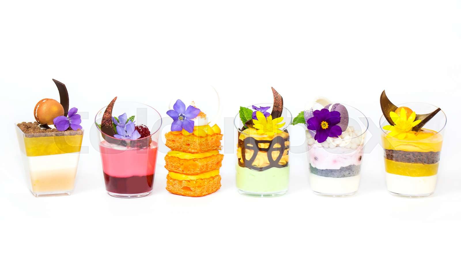 mini canapes in plastic cups decorated with edible flowers | Stock ...
