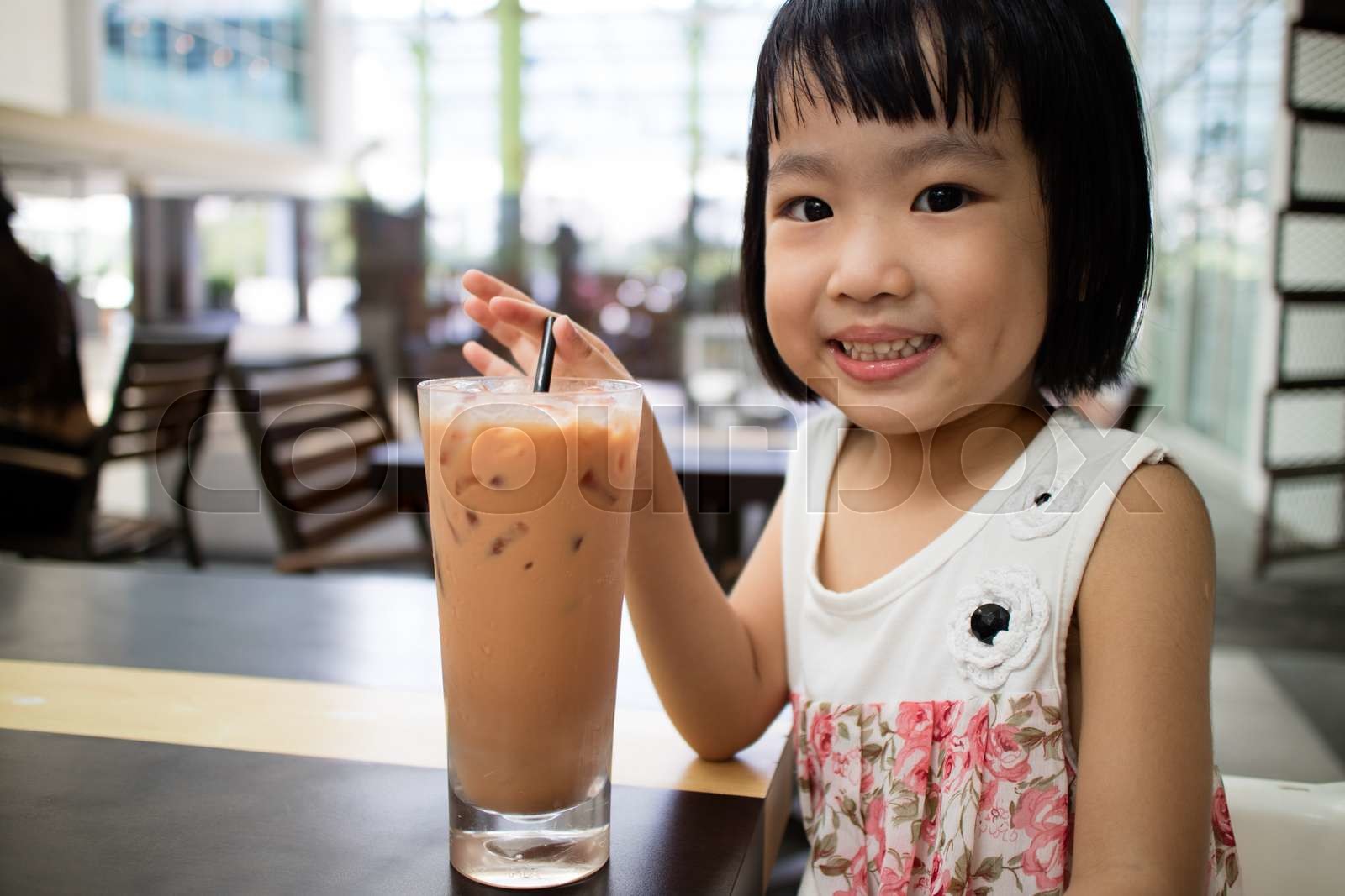 Asian Little Chinese Girl Drinking Ice Milk Tea | Stock image | Colourbox
