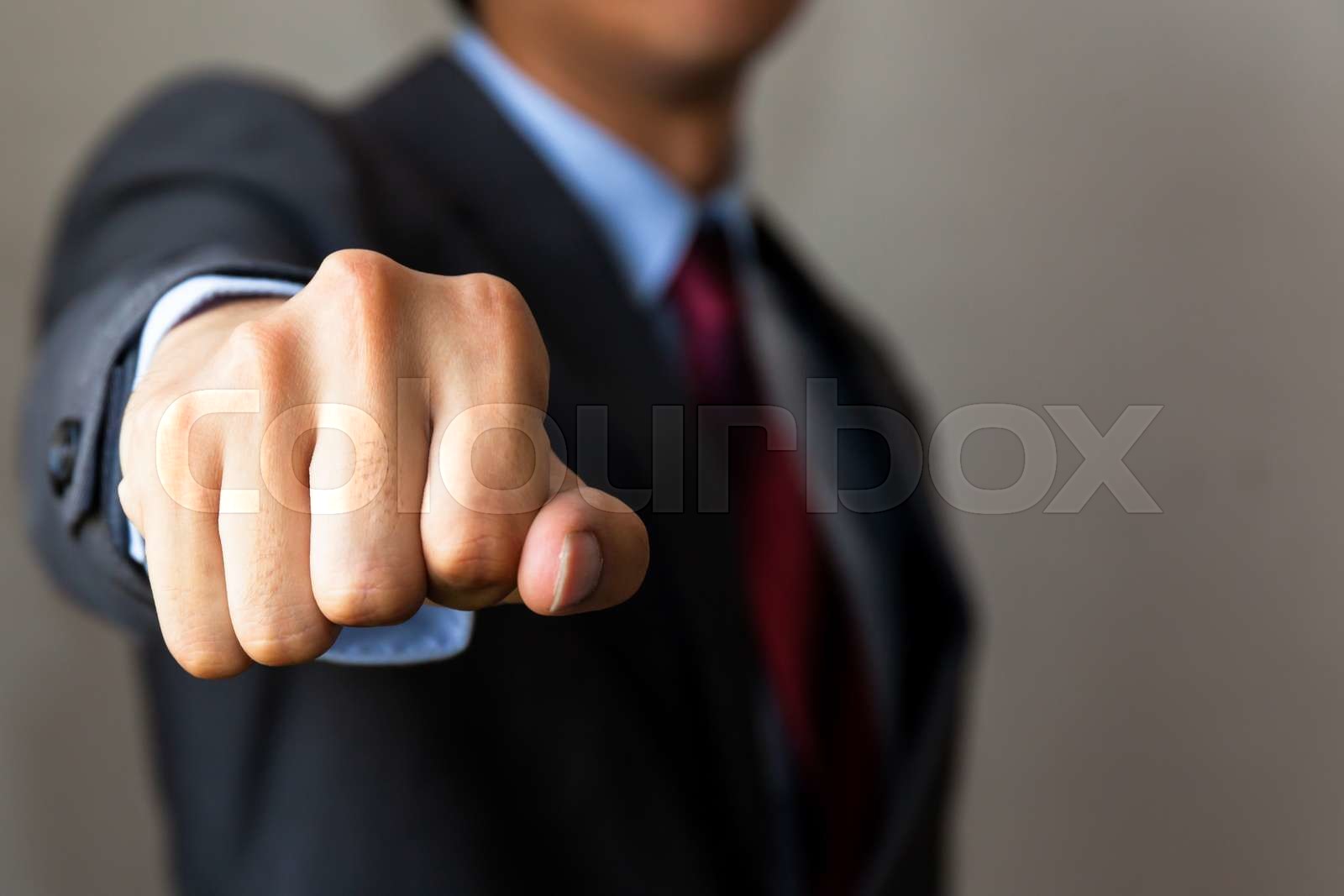 Businessman raising up his fist forward - it can be fist bump with ...