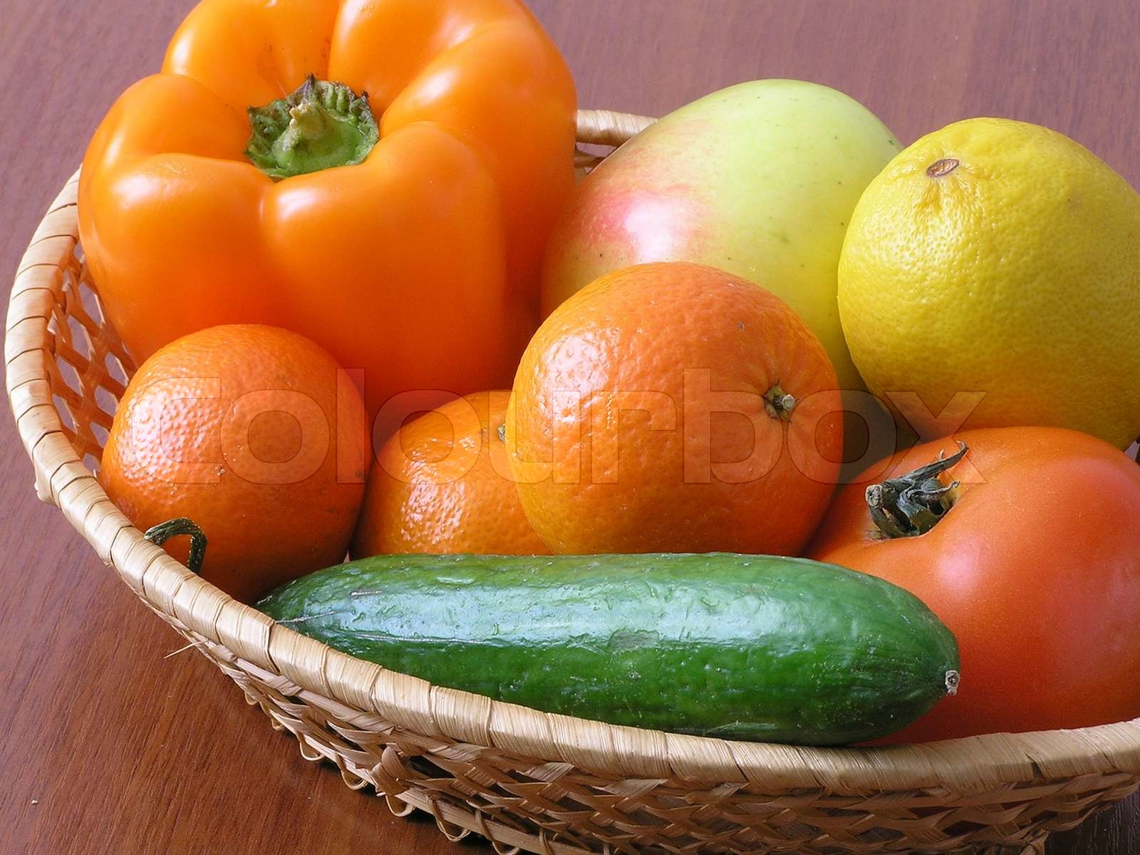 On a photo a basket in which different vegetables and fruit. The photo ...