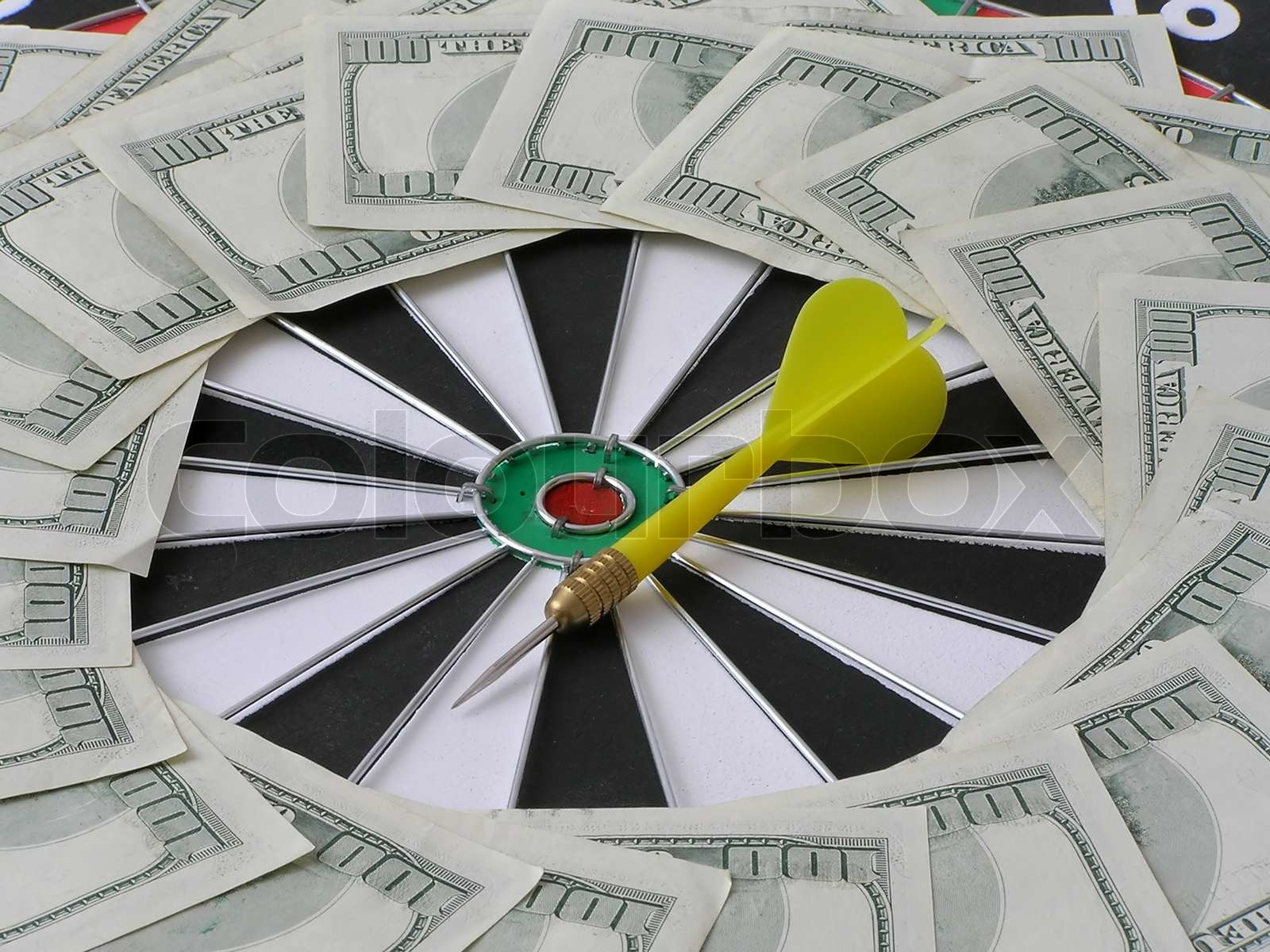 On a photo the target of a darts on which lays a pack of money. | Stock ...