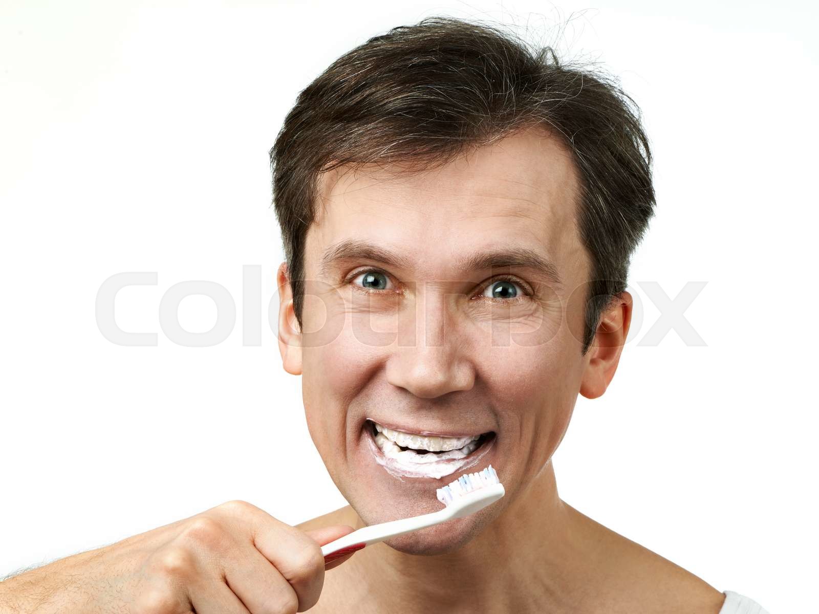 Man brushing his teeth | Stock image | Colourbox