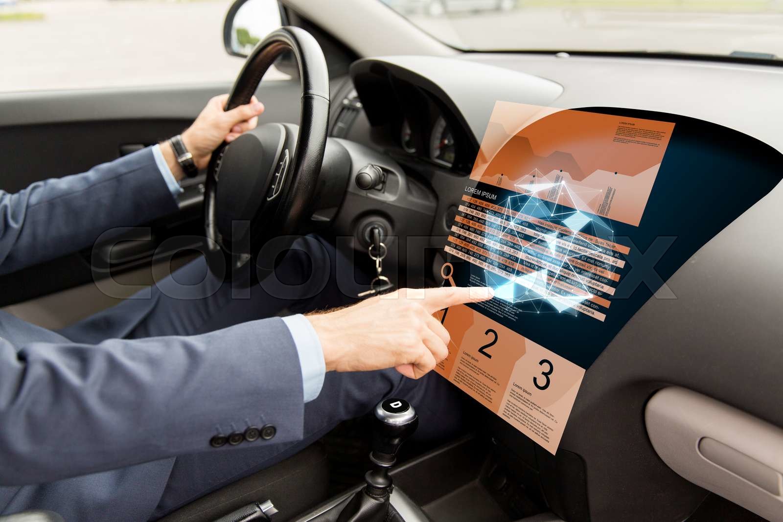 man driving car and pointing to on-board computer | Stock image | Colourbox