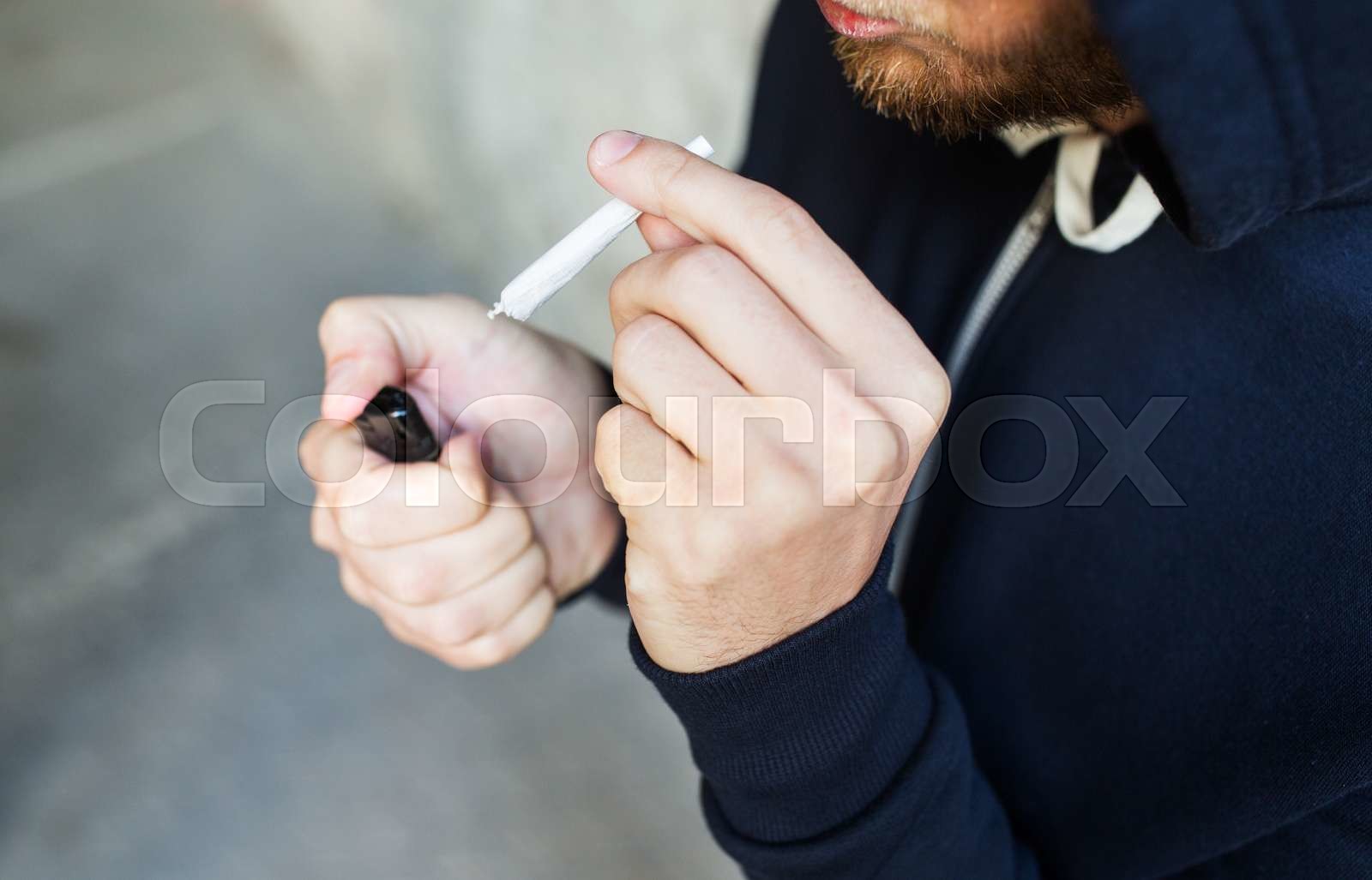 close up of addict smoking marijuana joint | Stock image | Colourbox