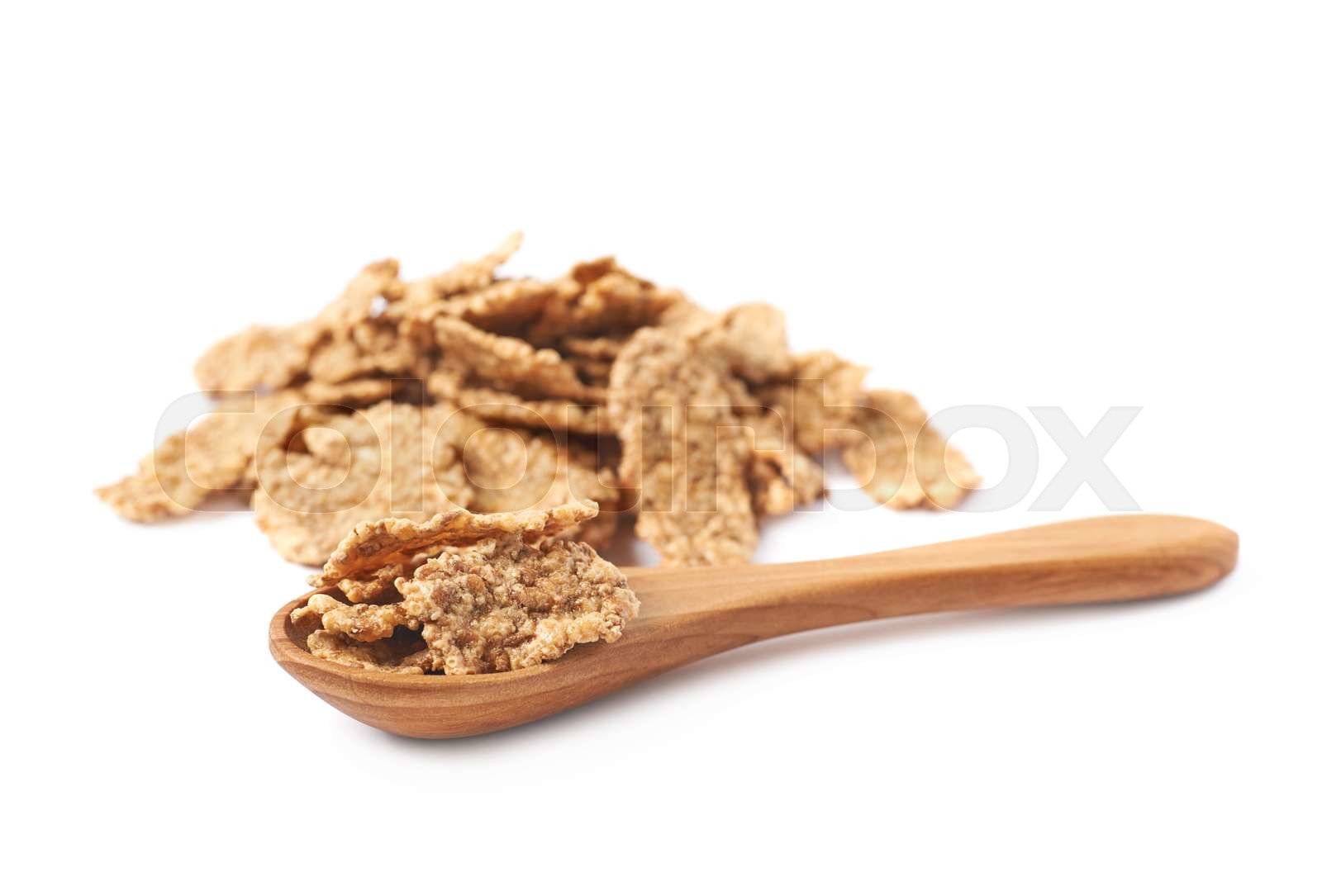 Pile of wholegrain cereal flakes isolated | Stock image | Colourbox