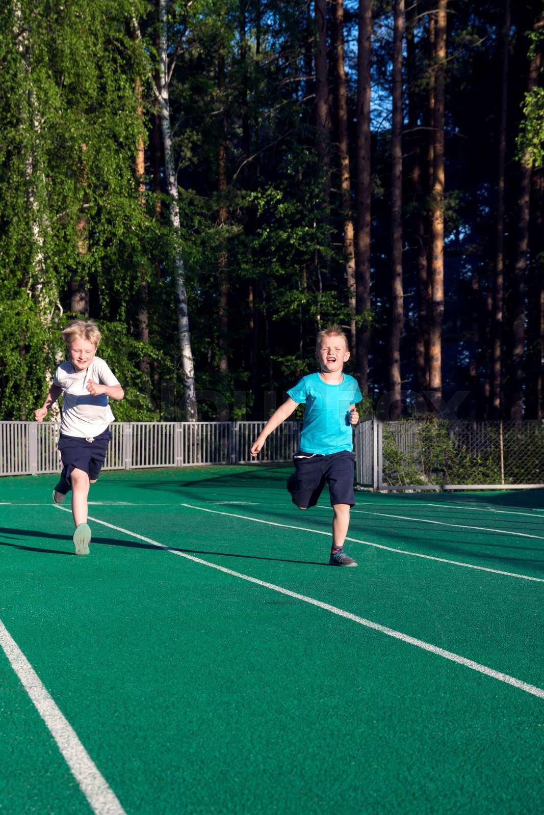 Boys running on track | Stock image | Colourbox