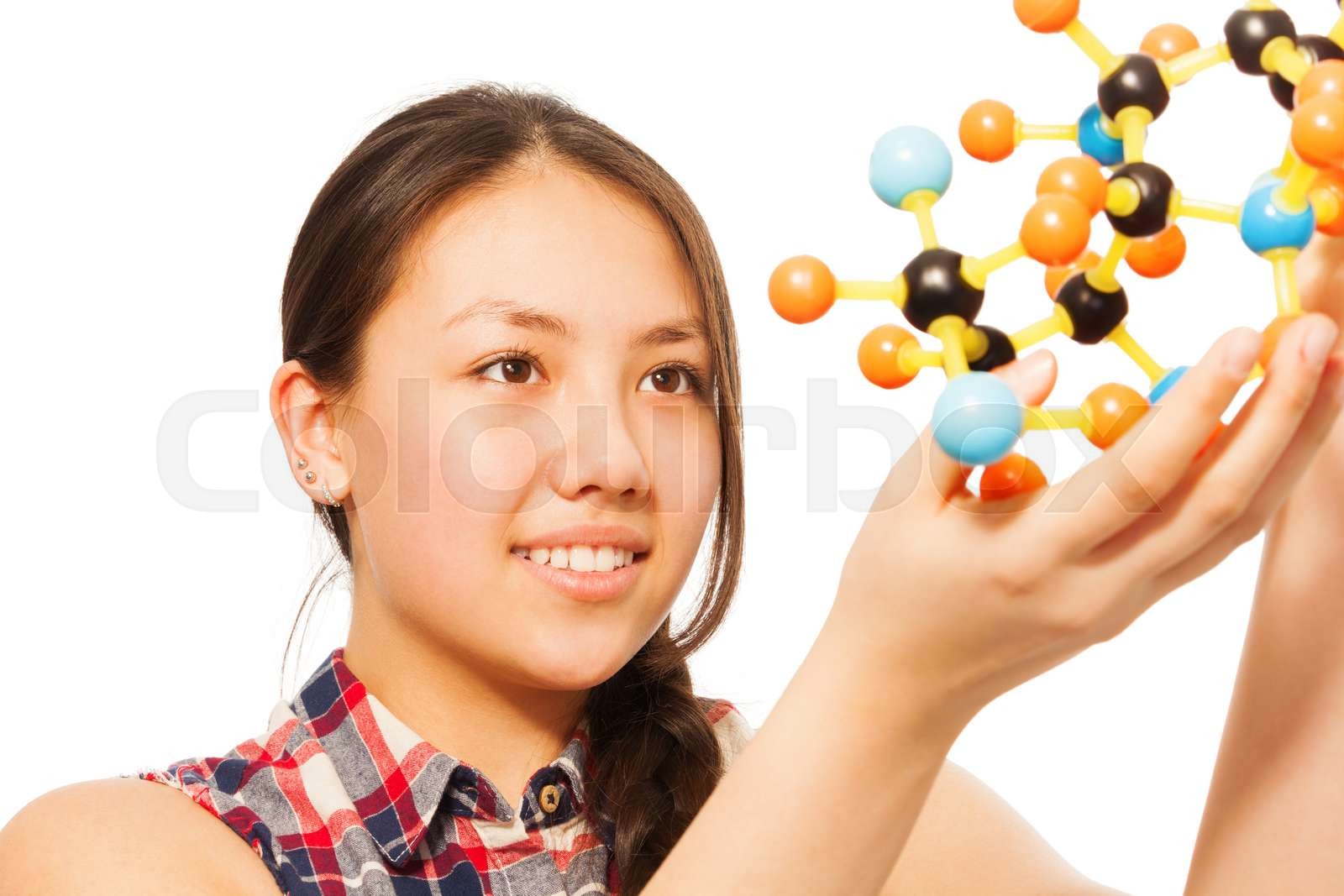 Asian student assembling molecule models | Stock image | Colourbox