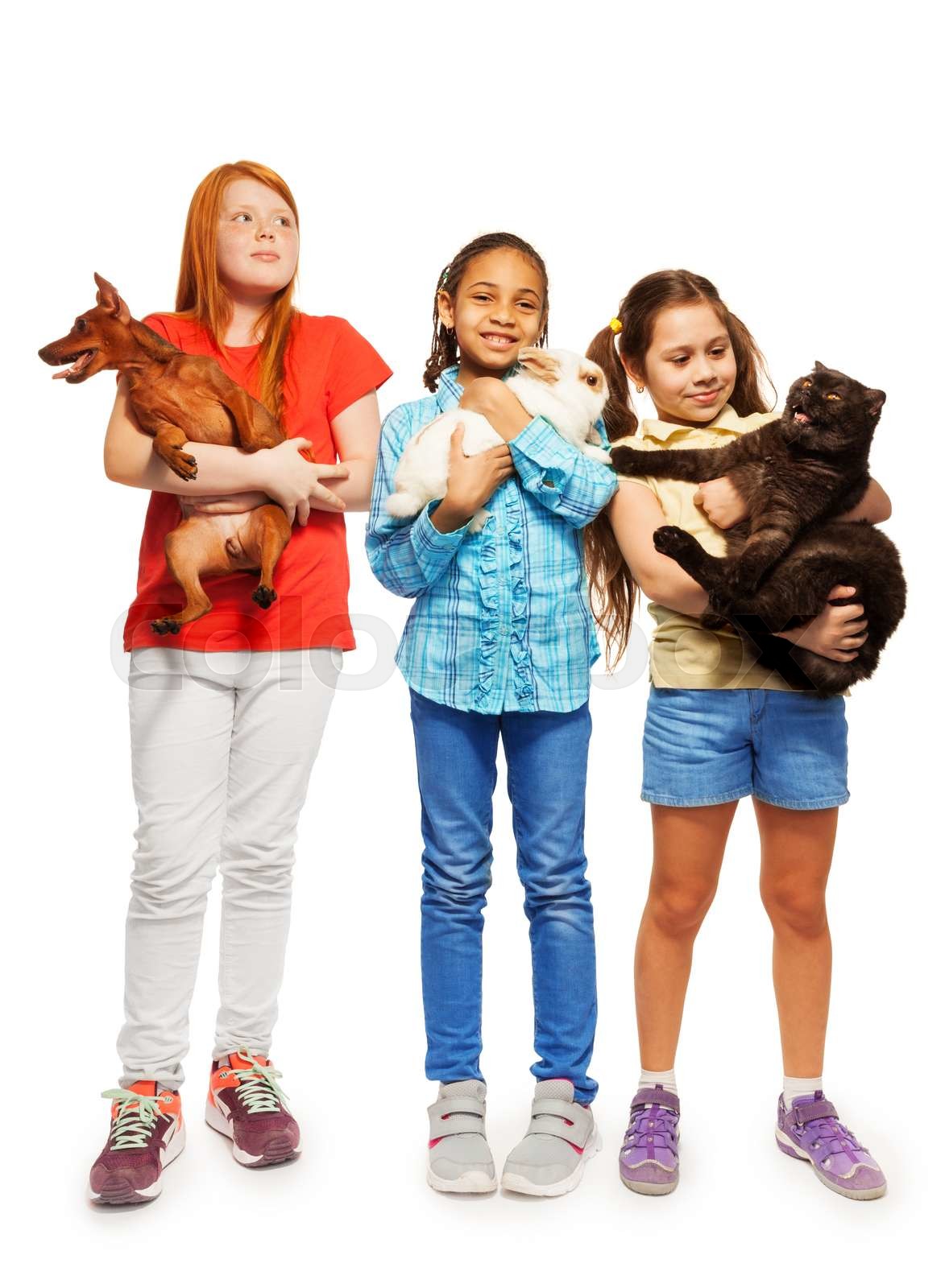 Three happy girls holding their beloved pets | Stock image | Colourbox