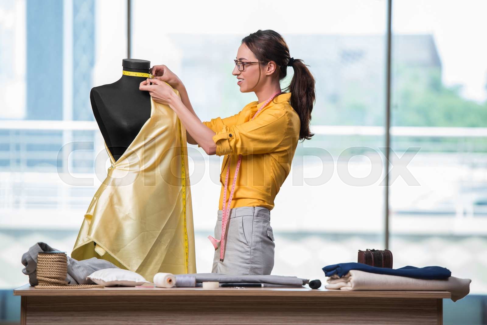 Woman tailor working on new clothing | Stock image | Colourbox