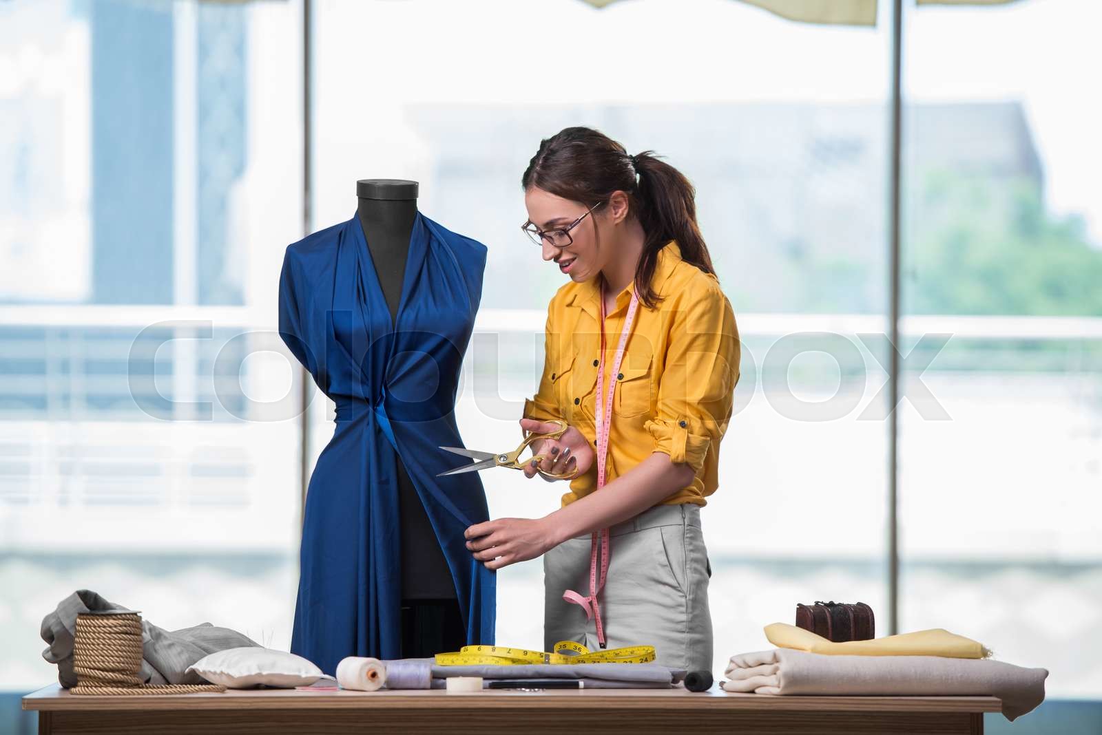 Woman tailor working on new clothing | Stock image | Colourbox