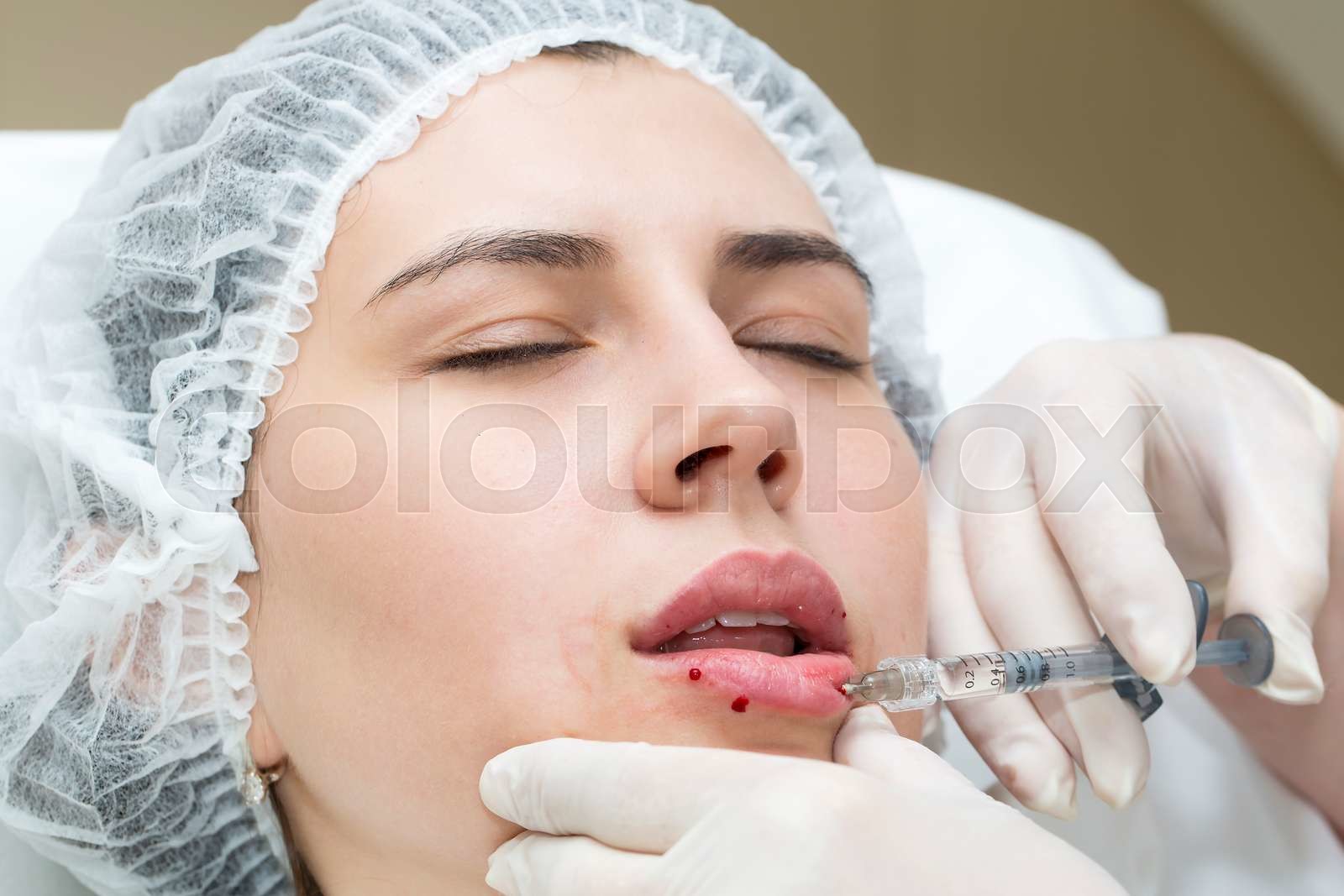 Cosmetic treatment with injection in a clinic | Stock image | Colourbox