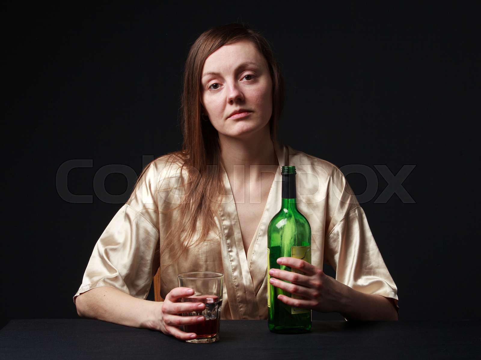 Alcohol addiction, black background | Stock image | Colourbox