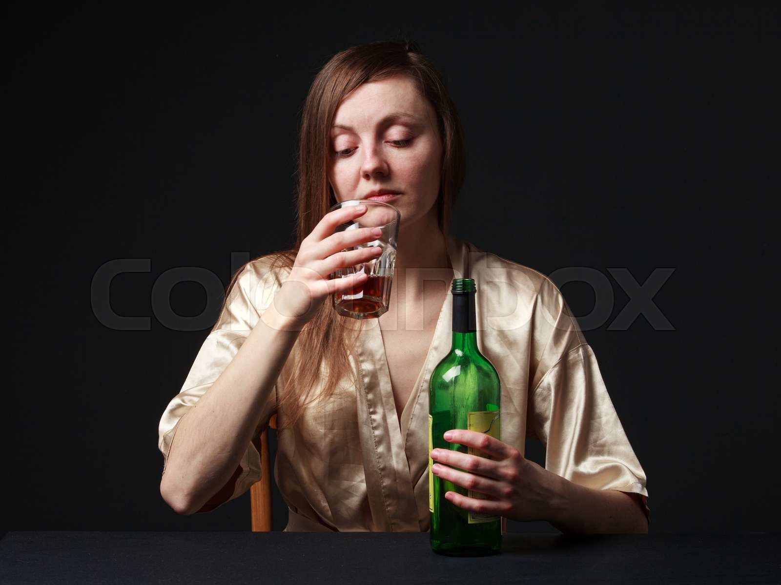 Alcohol addiction, black background | Stock image | Colourbox