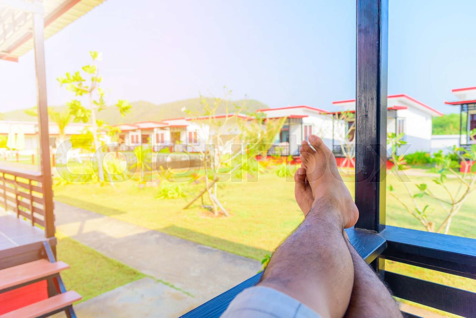 Man's feet relax in hotel | Stock image | Colourbox