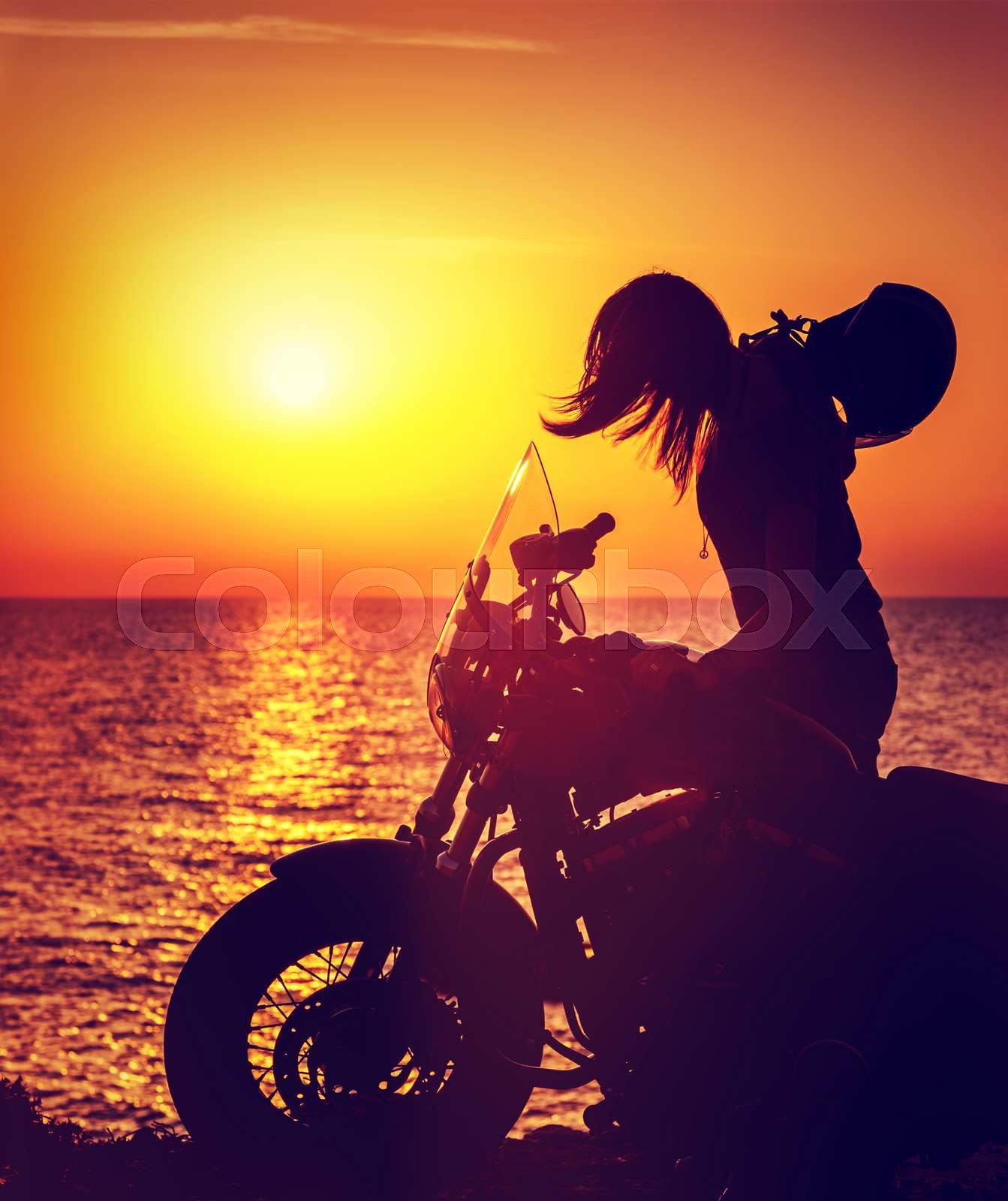 Silhouette of a biker woman | Stock image | Colourbox
