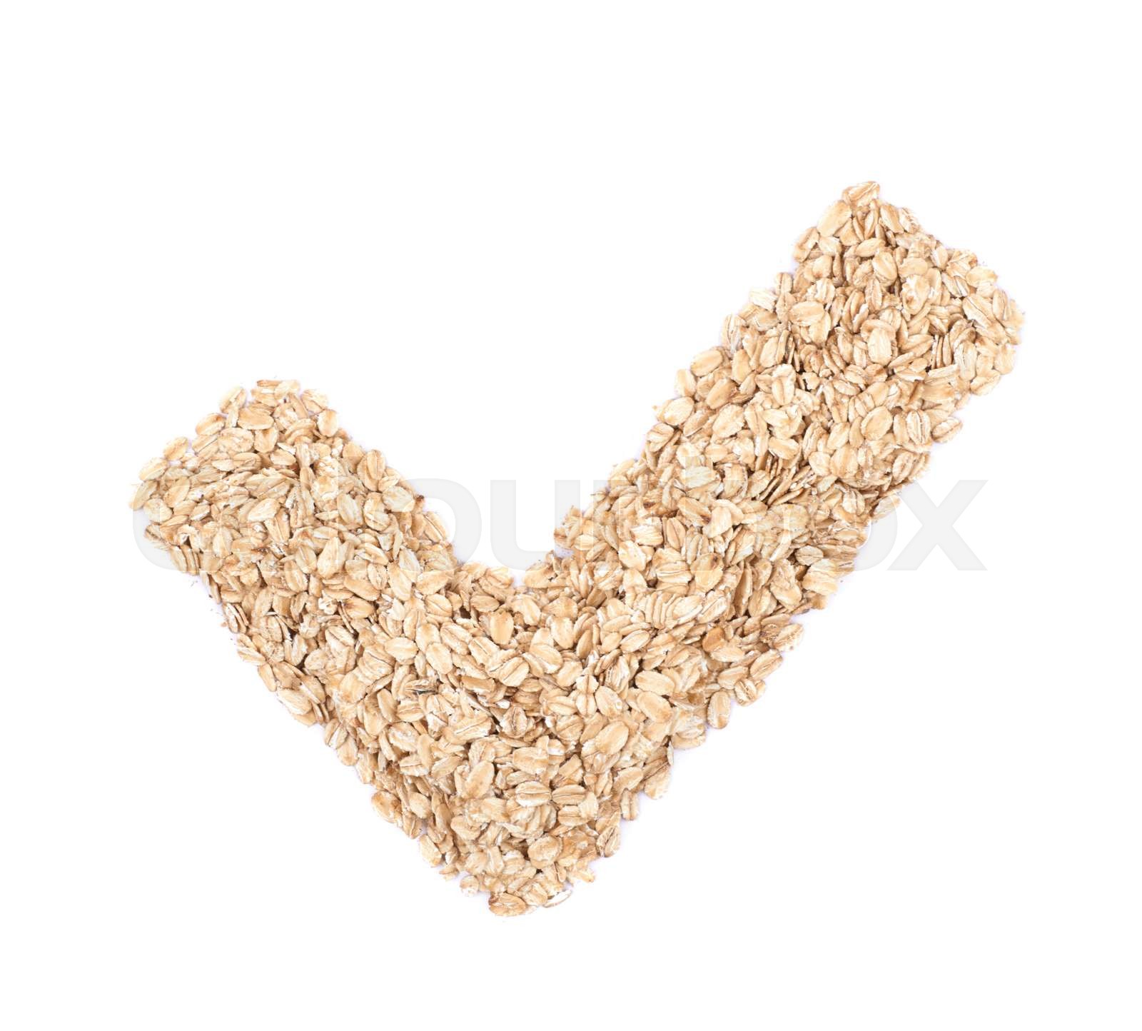 Tick shape made of oatmeal flakes | Stock image | Colourbox