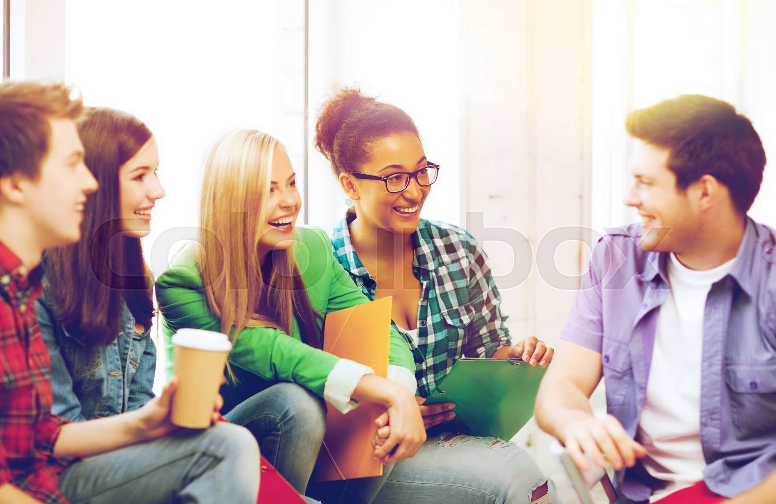 students communicating and laughing at school | Stock image | Colourbox
