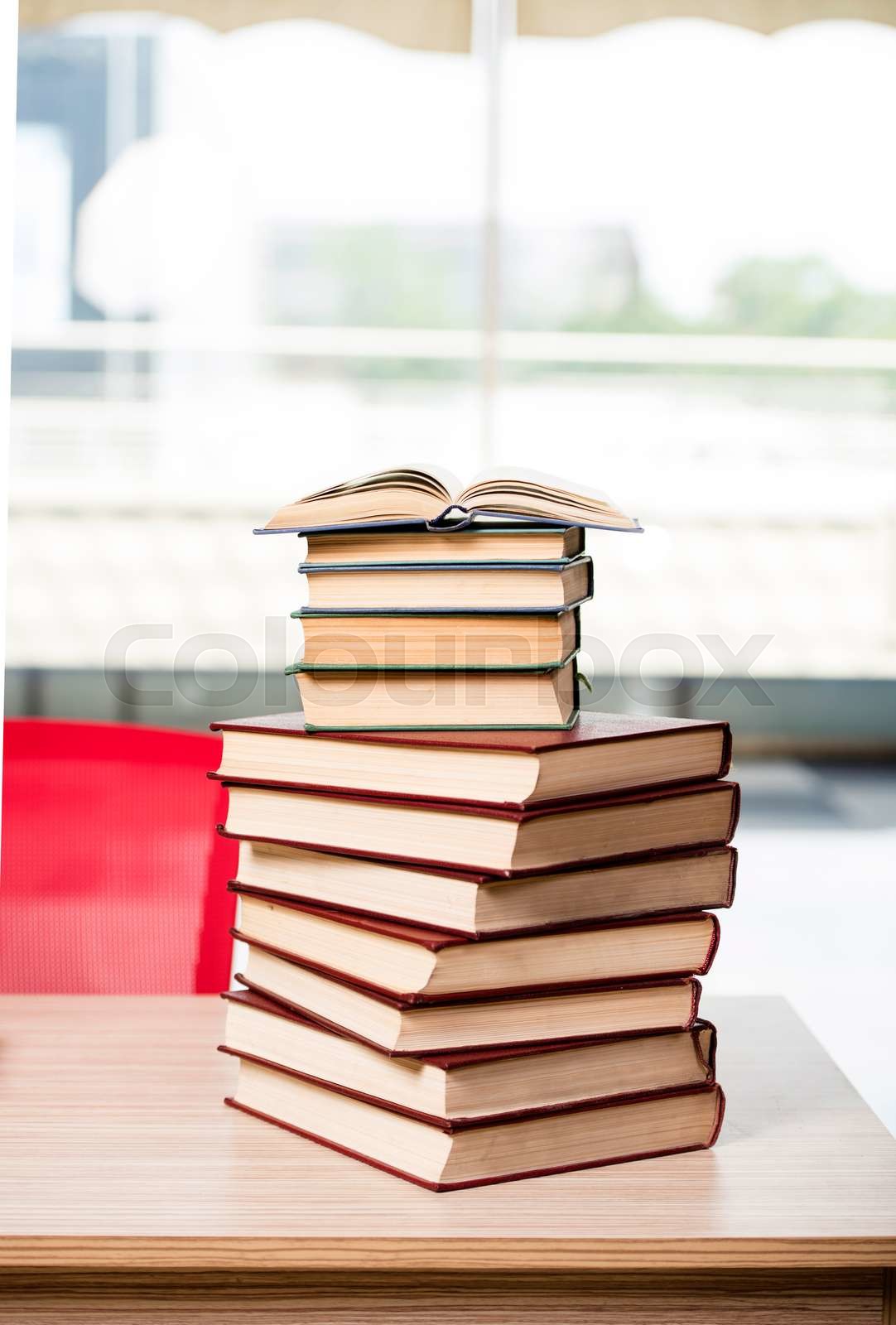 Stack of books arranged the office desk | Stock image | Colourbox