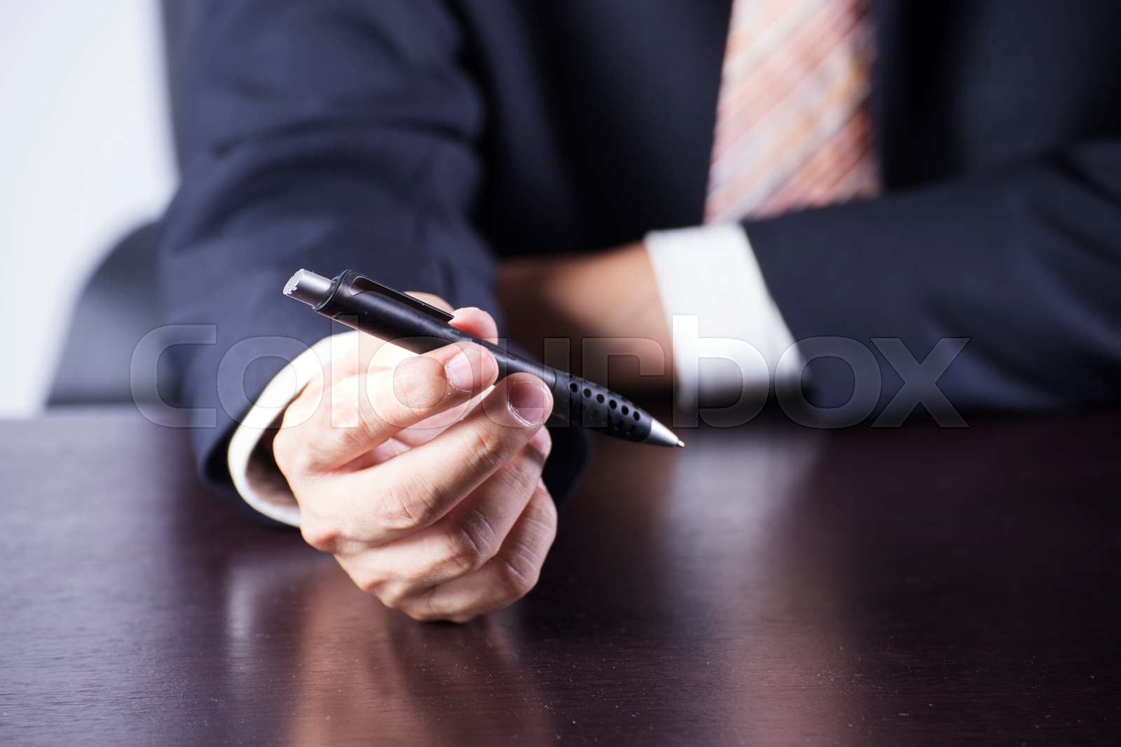 business man’s hands holding the pen | Stock image | Colourbox