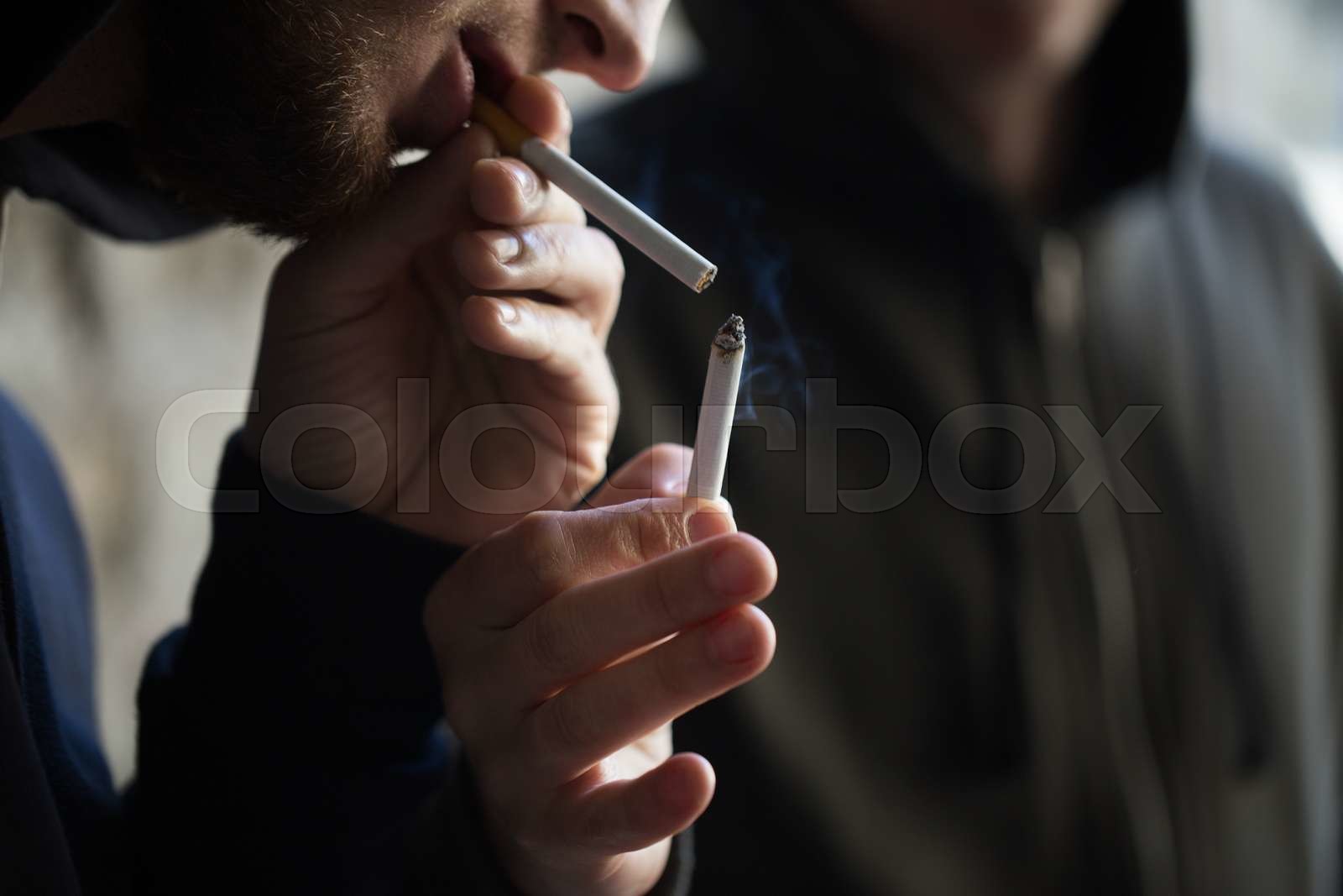 close up of young people smoking cigarette | Stock image | Colourbox