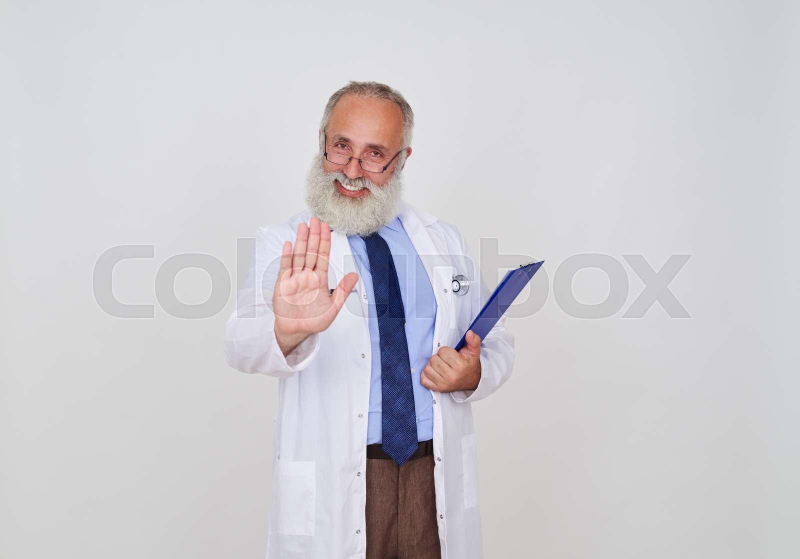 Mature doctor showing deny gesture | Stock image | Colourbox