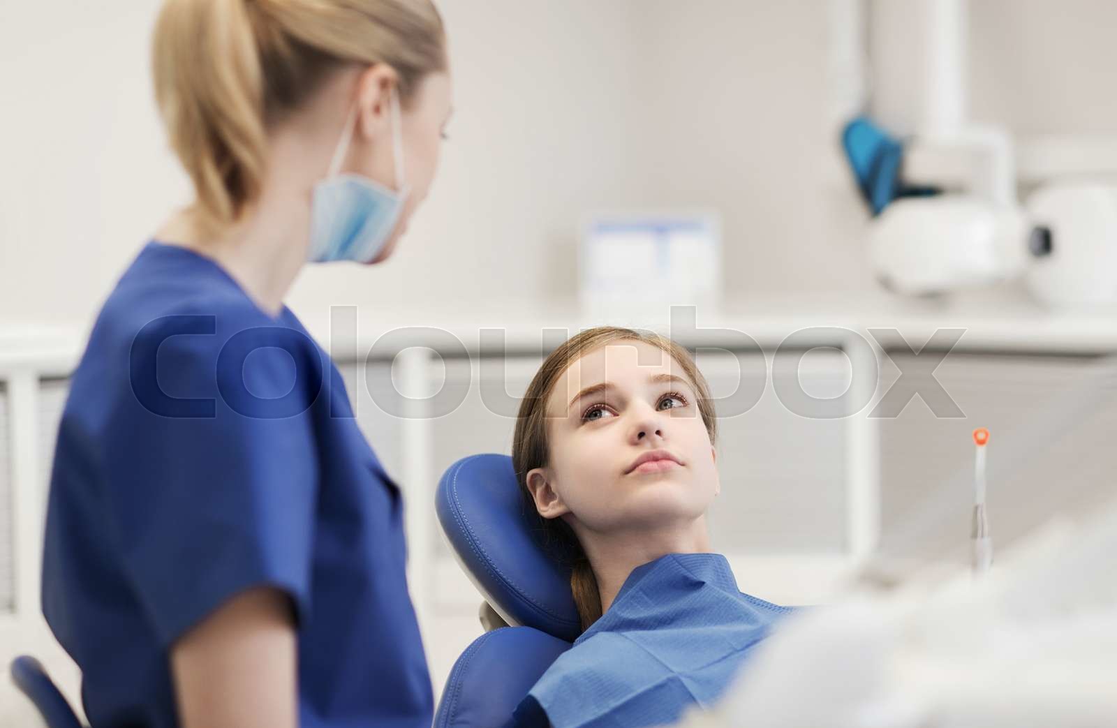happy female dentist with patient girl at clinic | Stock image | Colourbox
