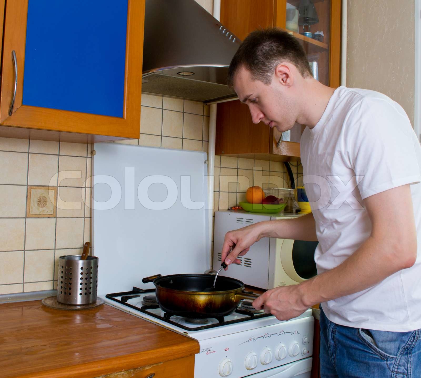adult man cooking at the kitchen alone | Stock image | Colourbox