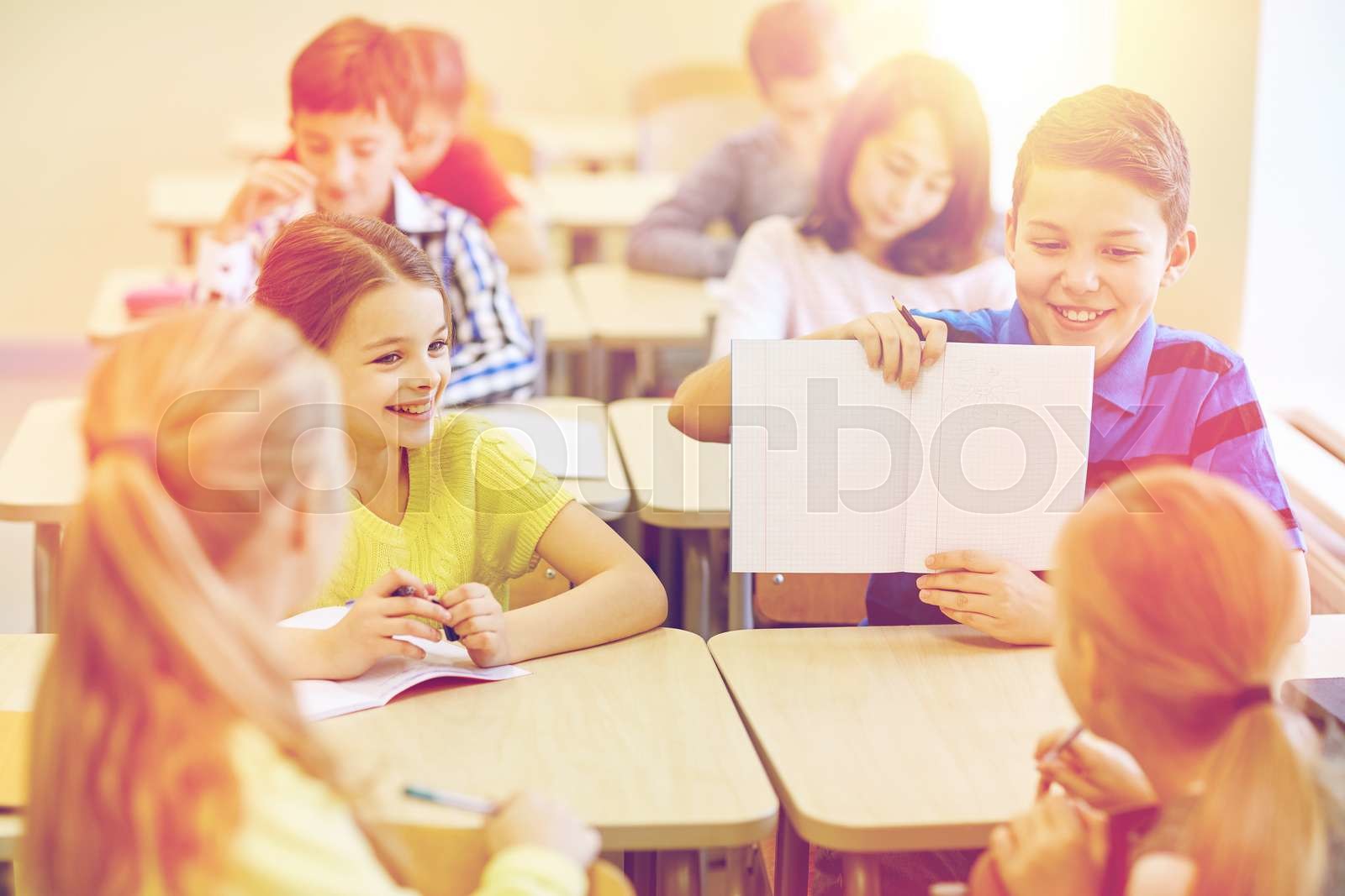 group of school kids writing test in classroom | Stock image | Colourbox