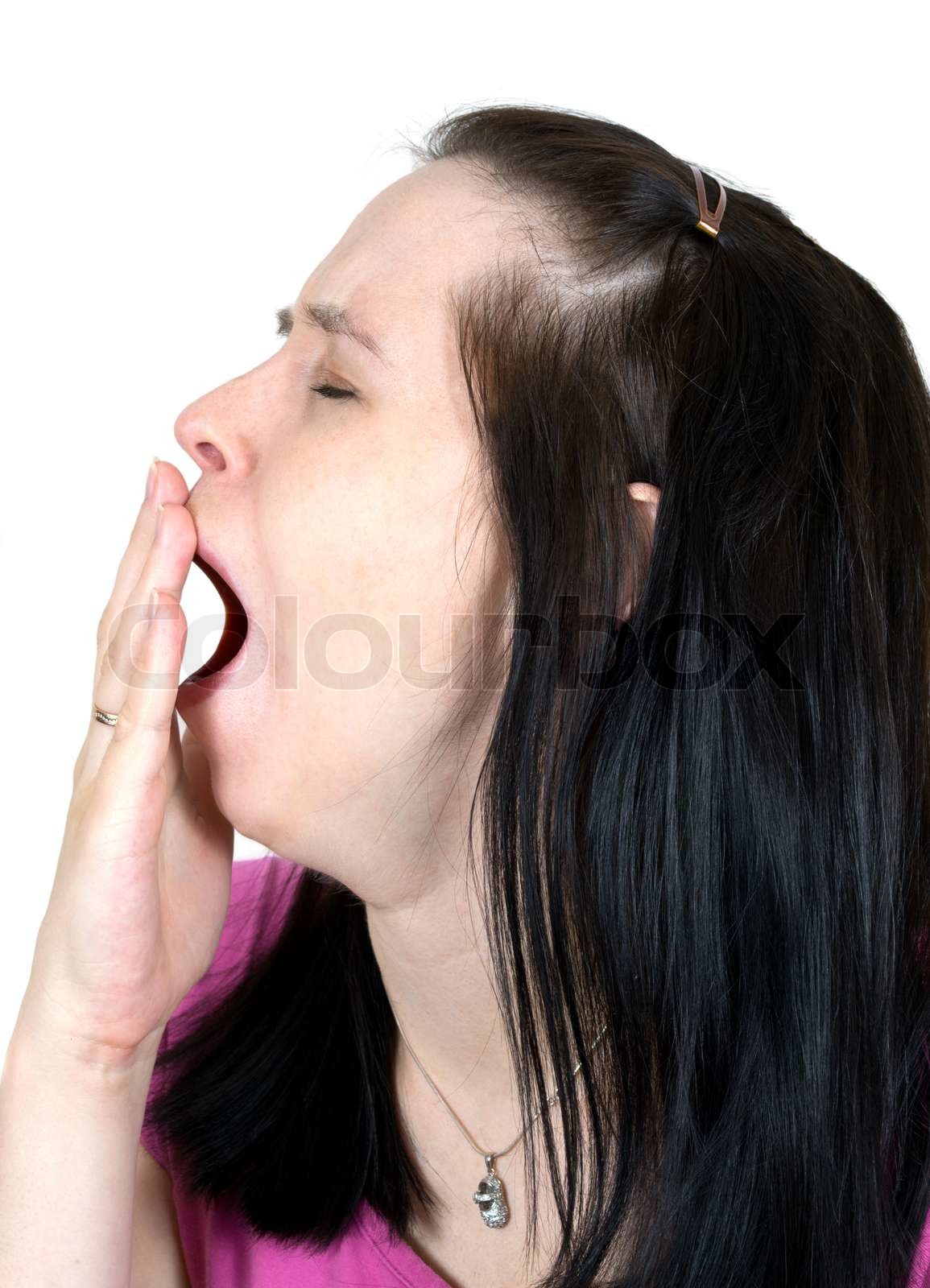 Yawning young woman isolated | Stock image | Colourbox