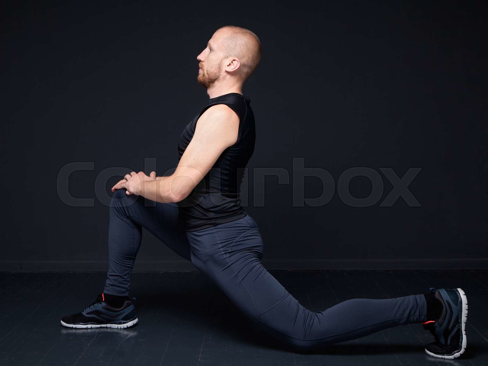 Fitness man doing stretching exercises | Stock image | Colourbox