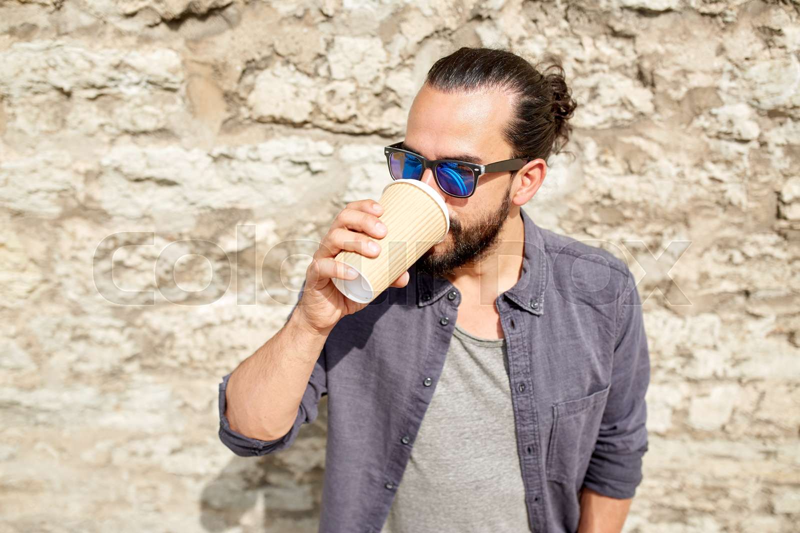 man drinking coffee from paper cup on street | Stock image | Colourbox