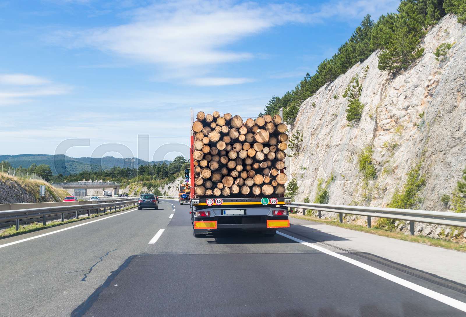 Truck carrying wood on motorway. | Stock image | Colourbox