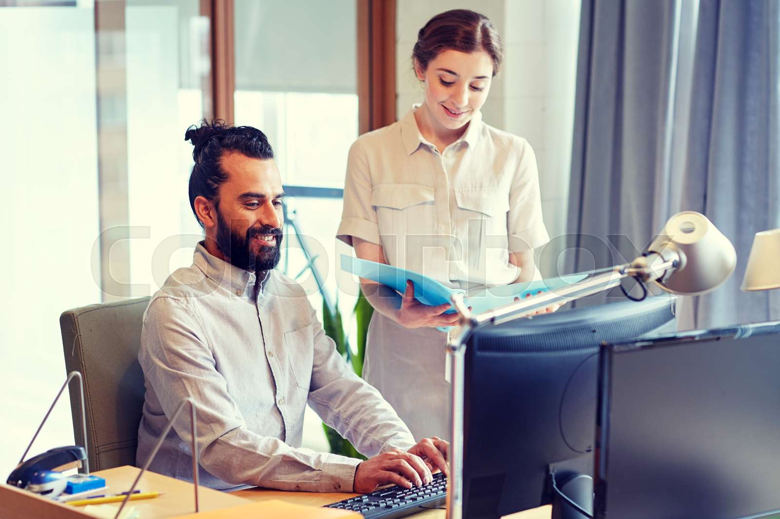 business team with computer and files in office | Stock image | Colourbox