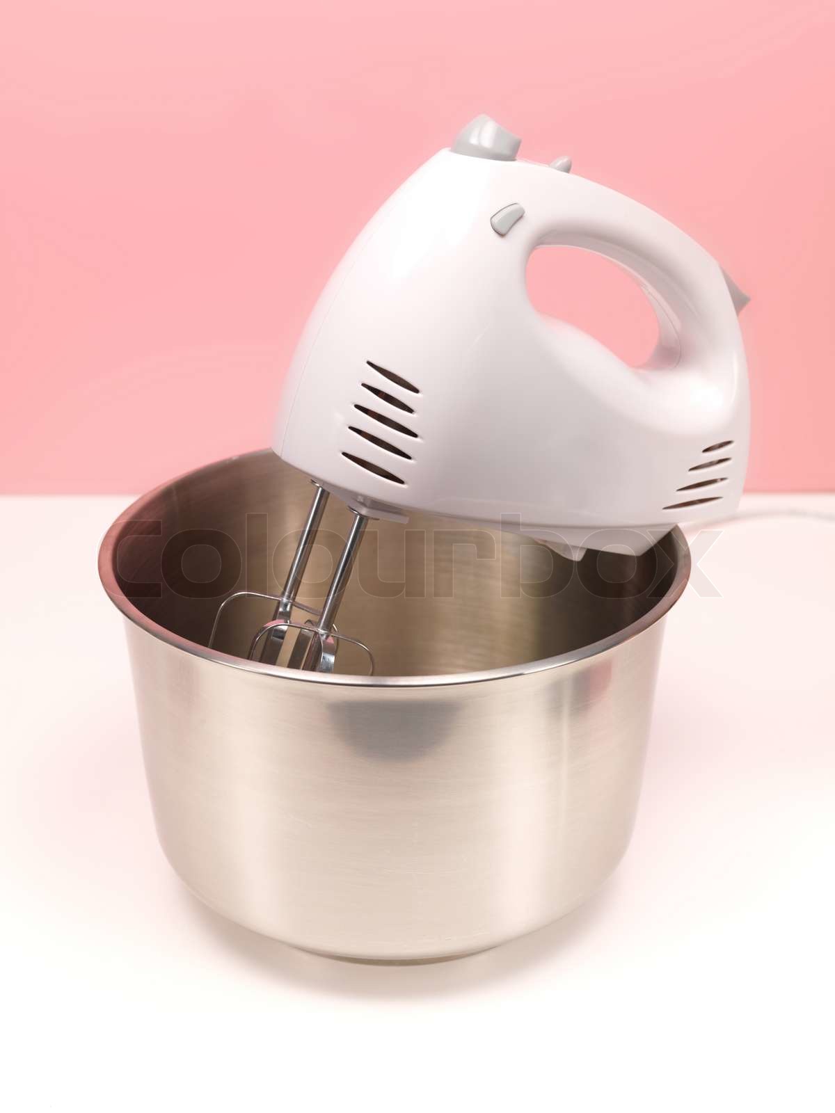 An electric hand mixer on a kitchen bench | Stock image | Colourbox