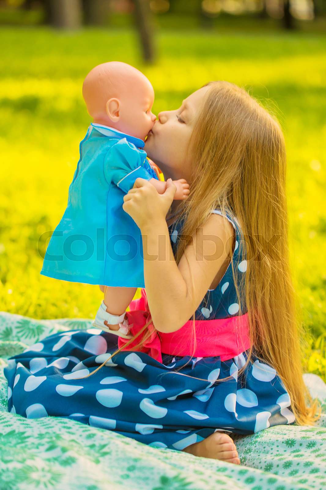 Little girl kissing her doll. | Stock image | Colourbox