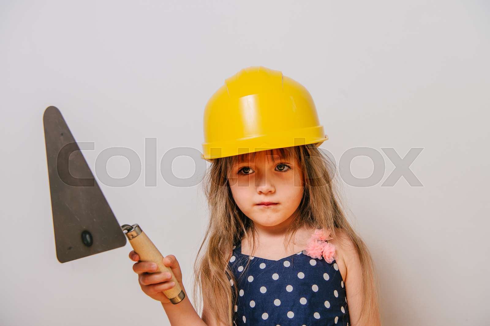 girl with construction tools. Little girl in polka-dot dress. little ...