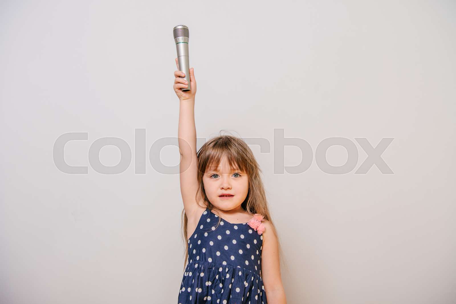 Girl with a microphone. little girl with a microphone. cute little girl ...
