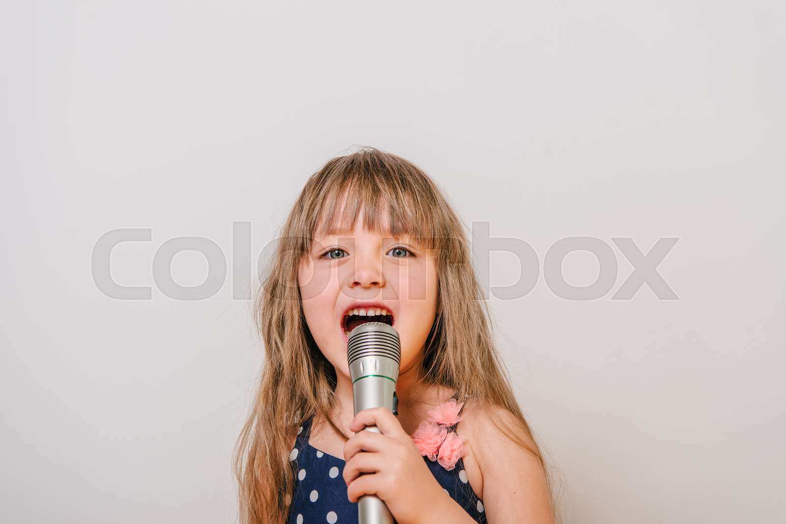 Girl with a microphone. little girl with a microphone. cute little girl ...