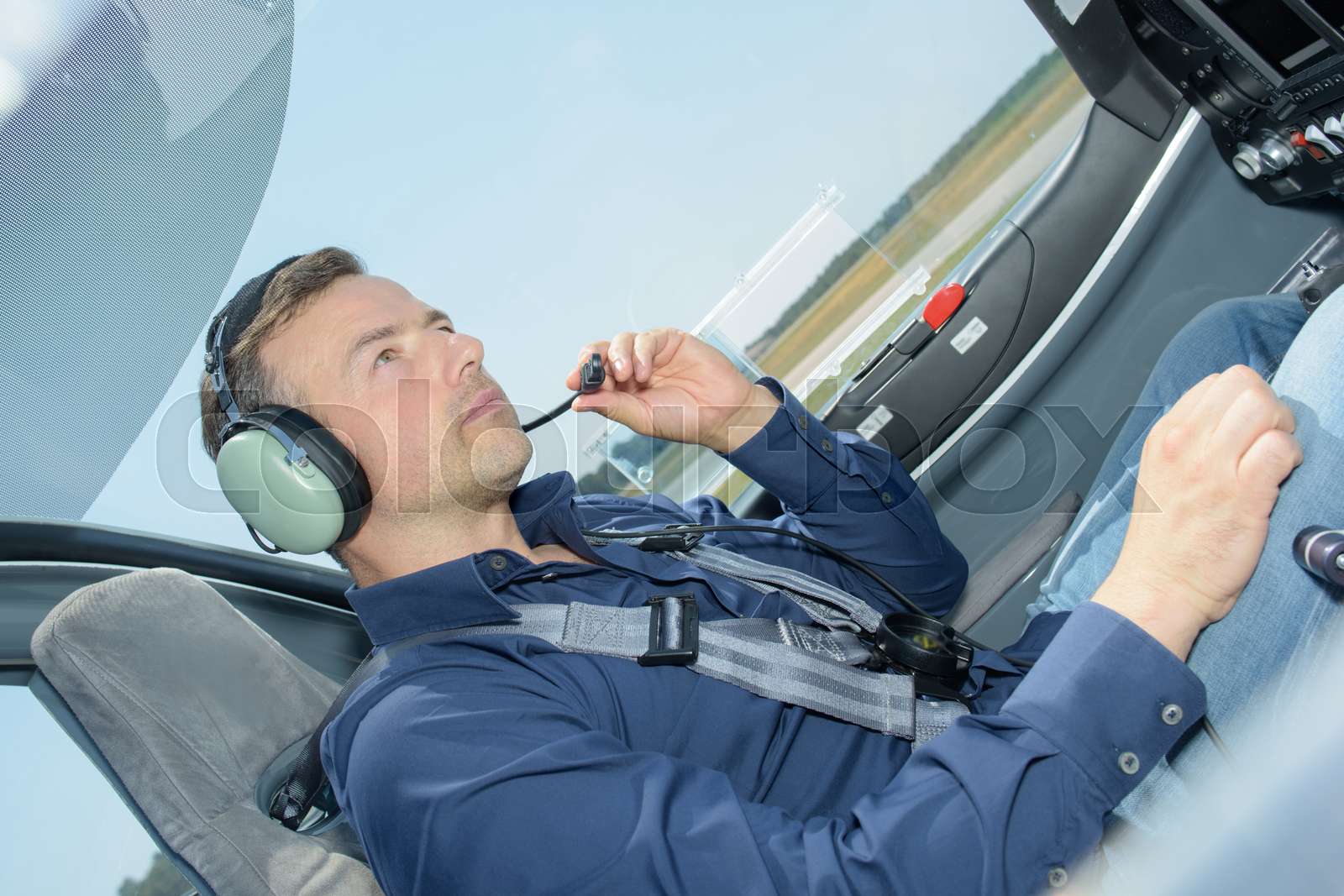 Pilot wearing headset with microphone | Stock image | Colourbox