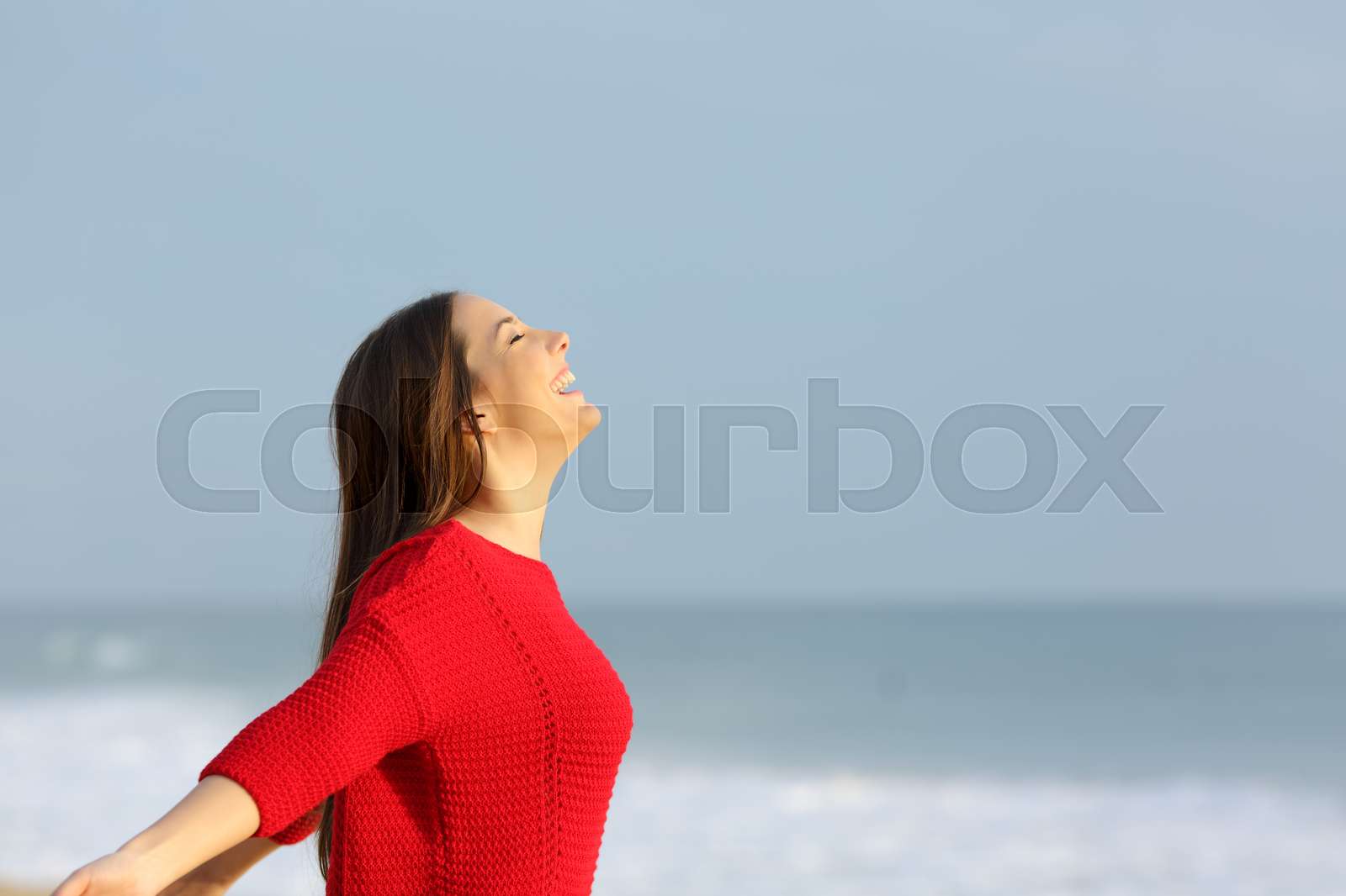 Woman in red breathing fresh air | Stock image | Colourbox